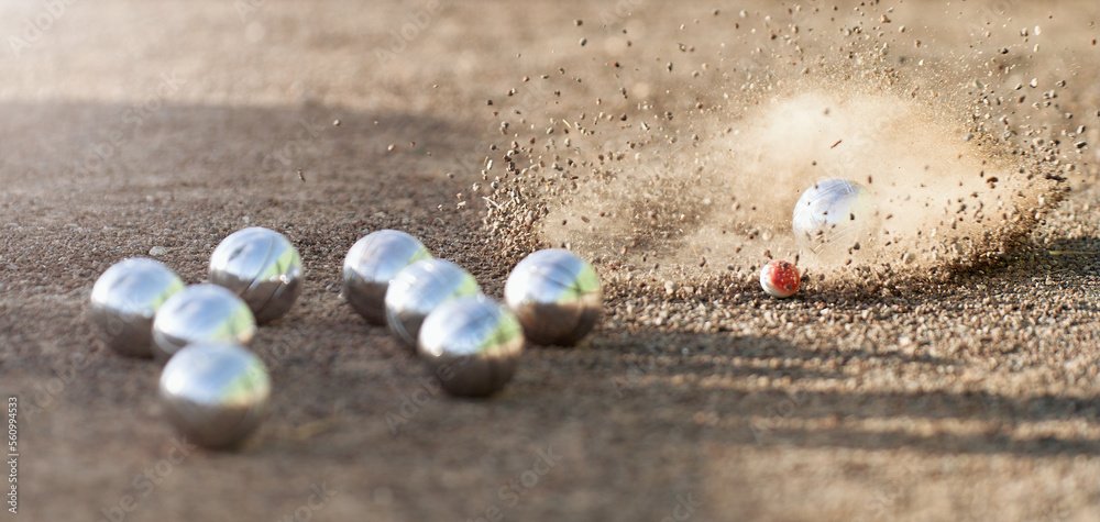 Petanque ball boules bowls on a dust floor, photo in impact. Game of ...
