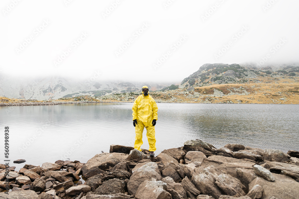 Person wearing yellow hazmat suit during Covid 19 pandemic Stock Photo ...
