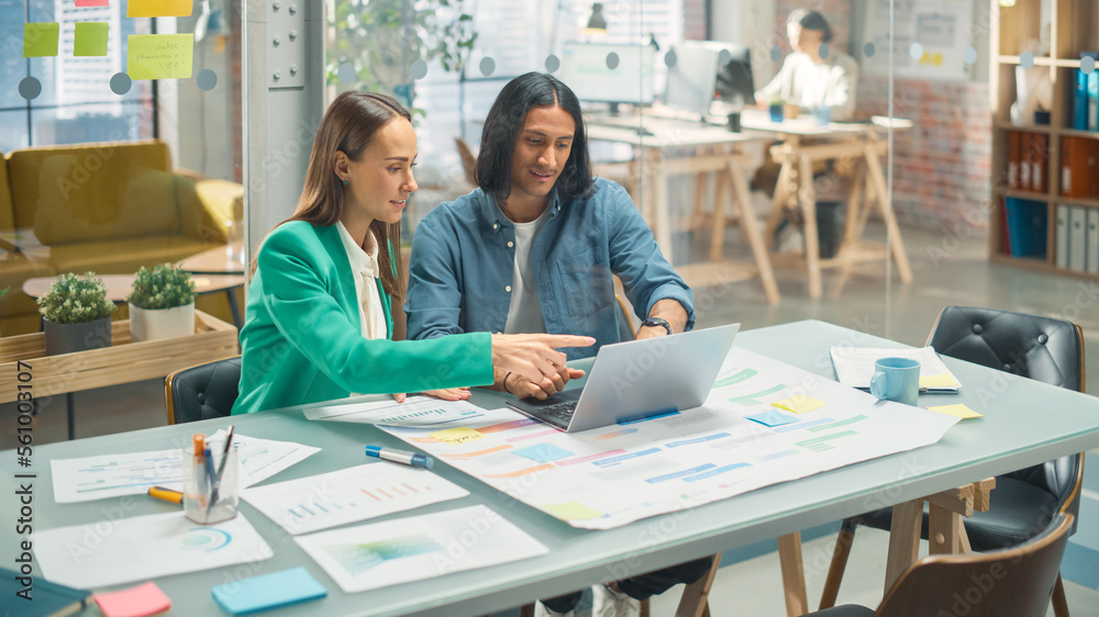 Portrait of Two Creative Colleagues Collaborating and Pointing at the ...