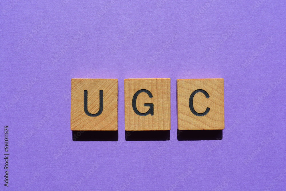 UGC acronym for User Generated Content isolated on purple background ...