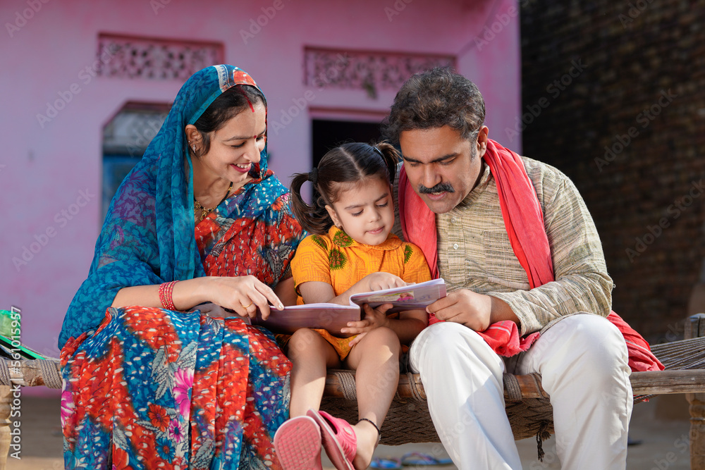 education concept : Indian parents teaching to little daughter at home ...