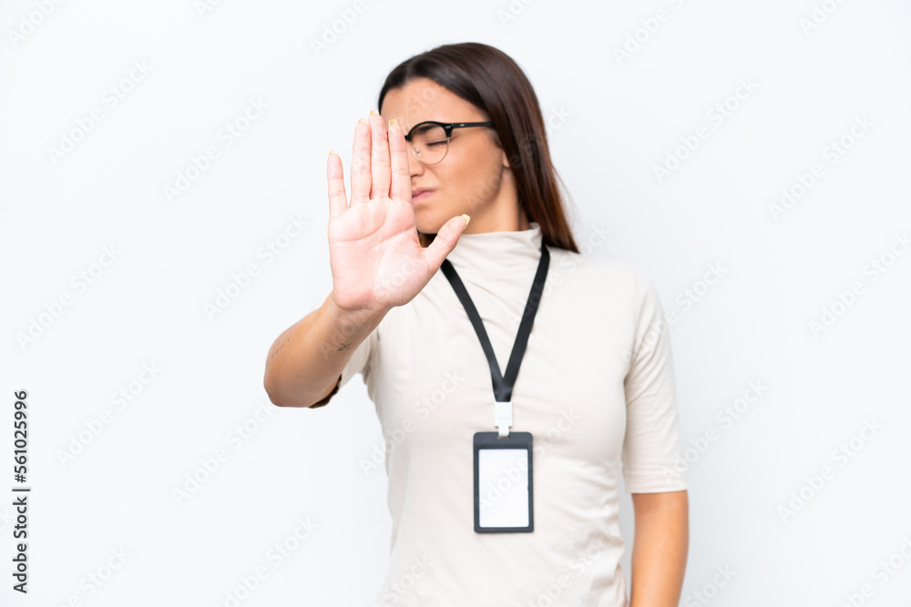 Young caucasian woman with ID card isolated on white background making ...