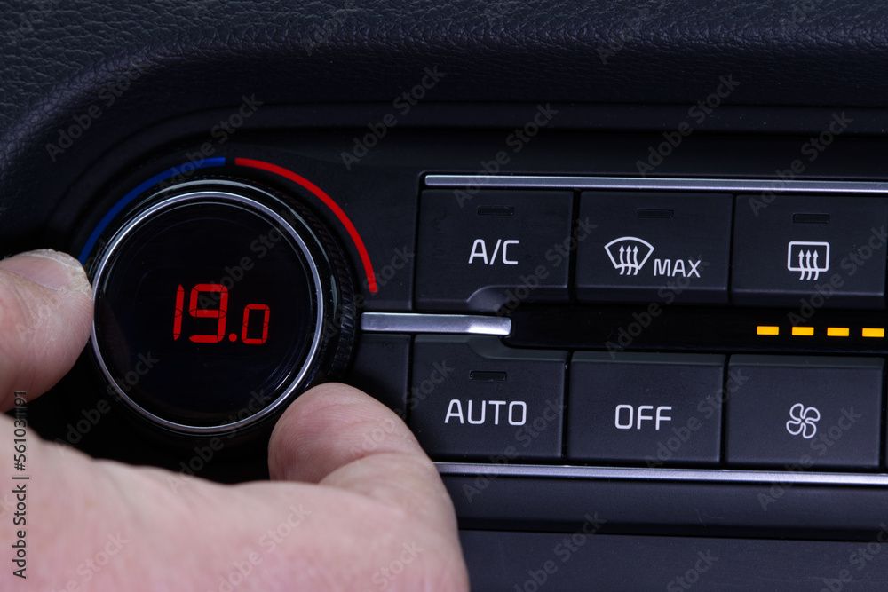 Set up air conditioner in the car. Hand turns air conditioner ring ...