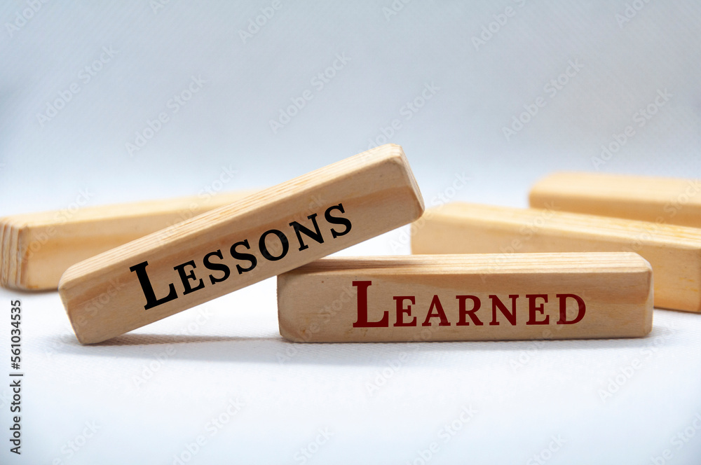 Lessons learned text on wooden blocks on white cover background ...
