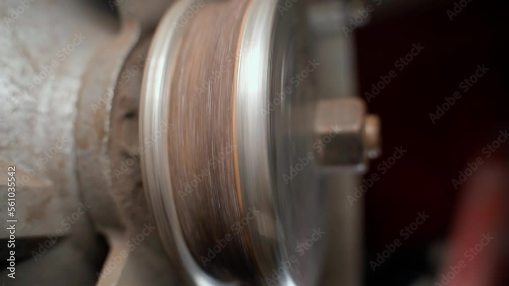 Sharpened abrasive wheel on a grinding machine close-up. Stopping the ...