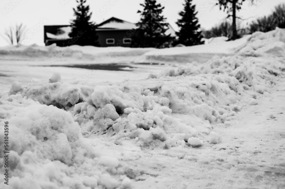 Snowbank at the end of a driveway left after city snowplows cleared a ...