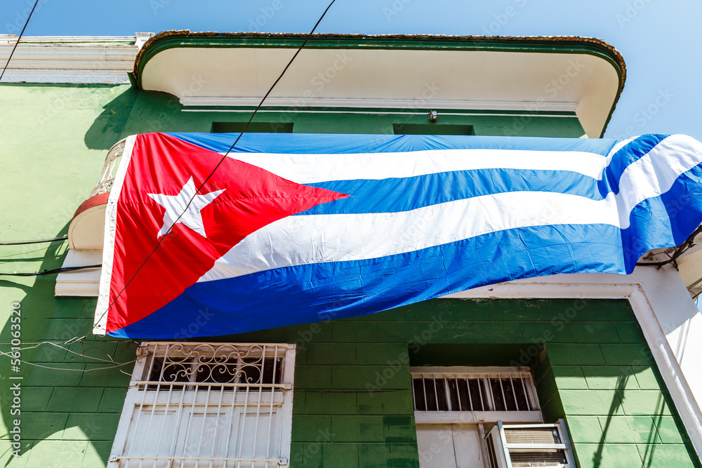 Big Cuban flag on the facade of a green colonial house in Trinidad ...