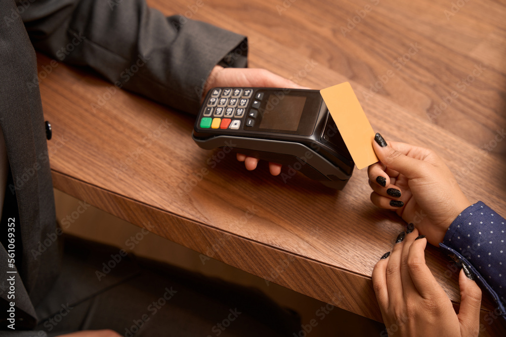 Female paying for service with credit card Stock Photo | Adobe Stock