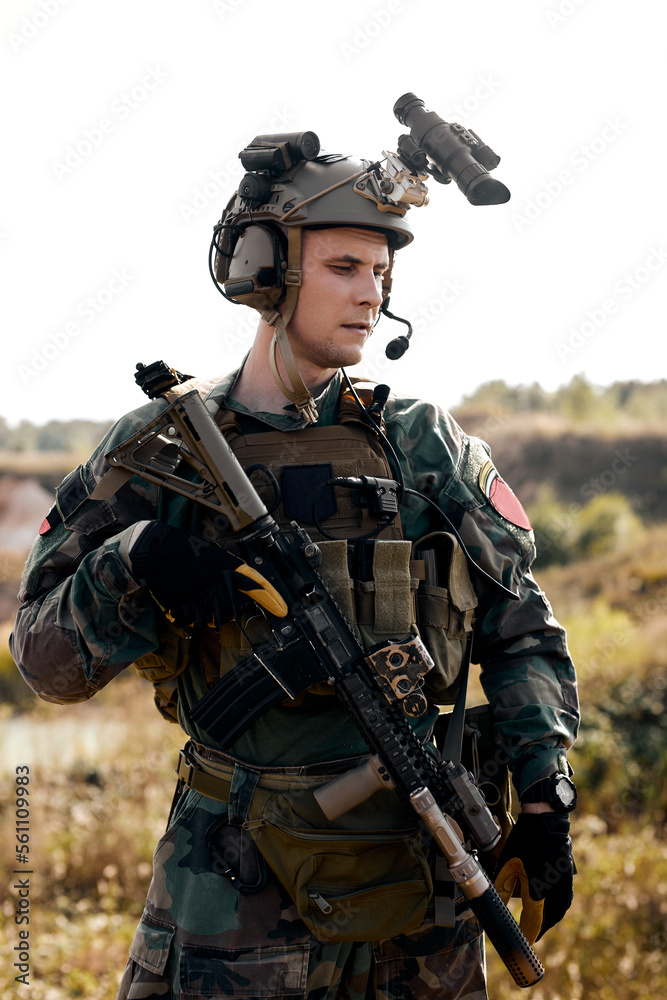 Serious soldier person with rifle during military operation, portrait ...