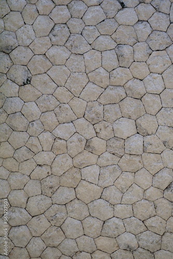 Rounded white and cream Balinese Palimanan stone wall. Texture and ...