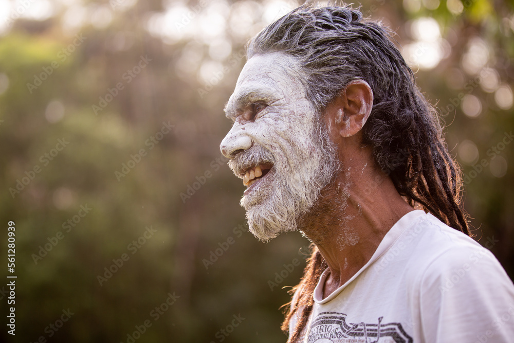 Aboriginal man wearing white face paint smiling Stock Photo | Adobe Stock