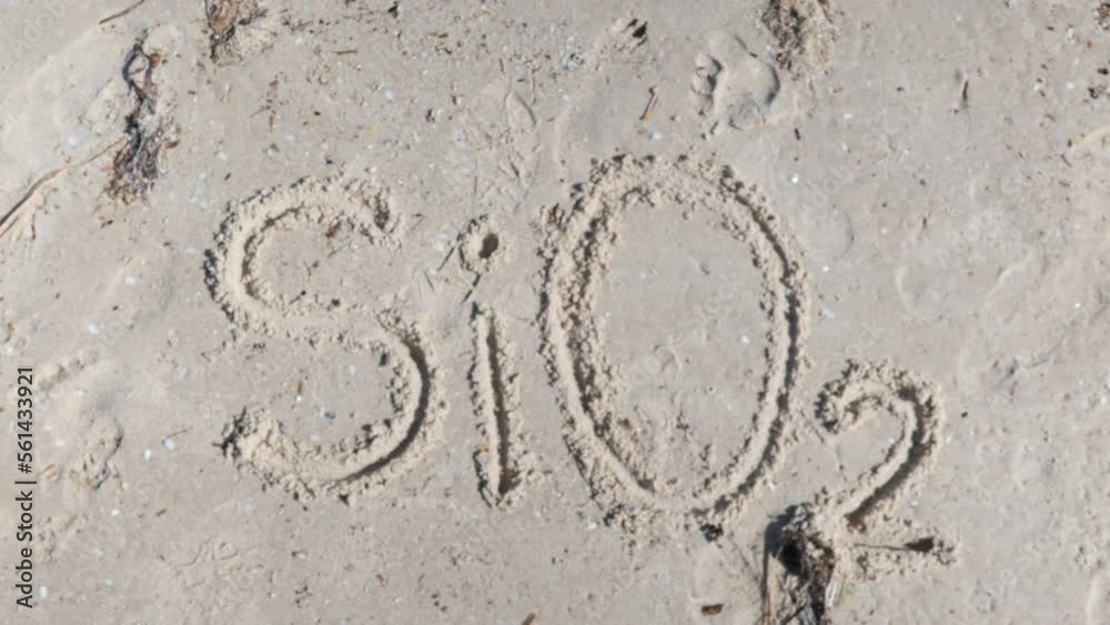 SiO2 Silicon Dioxide Silica written on beach in sand with finger Height ...