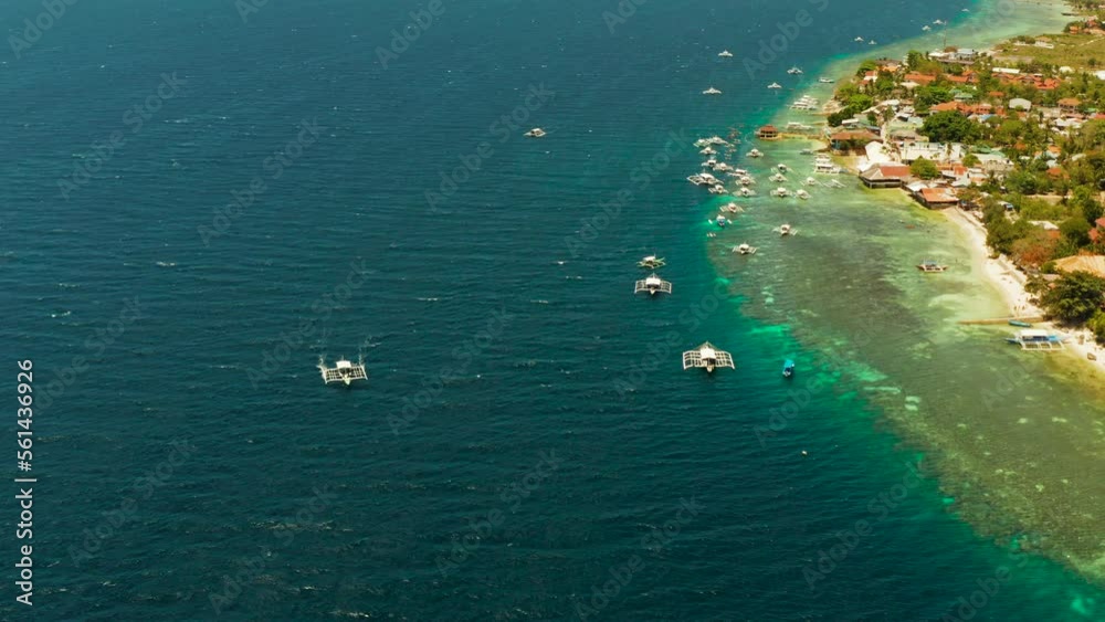 Coral reef and turquoise water with Philippine boats in the famous ...