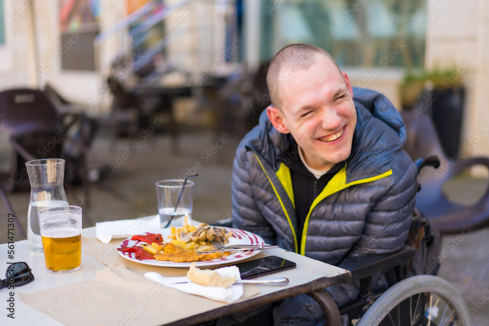 Portrait of a disabled person in a wheelchair in a restaurant smiling ...