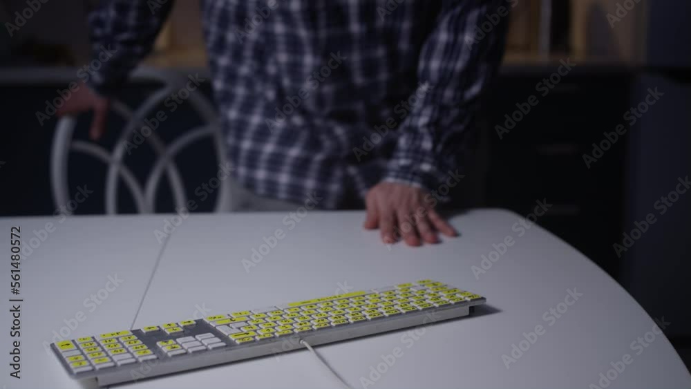 Close-up: A man uses a keyboard with braille.A blind man is typing ...