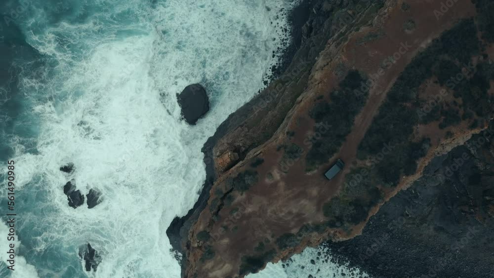 Epic and majestic aerial top down view on small 4x4 camper van drive on ...