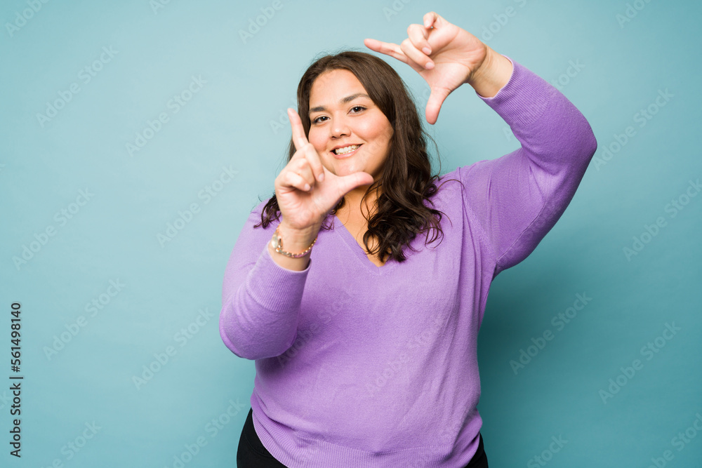 Beautiful woman framing a picture with her hands Stock Photo | Adobe Stock