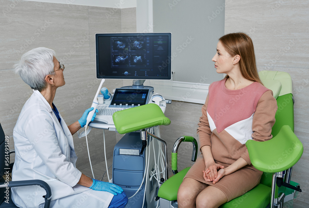 Doctor with ultrasound transvaginal sensor for ultrasound procedure to ...