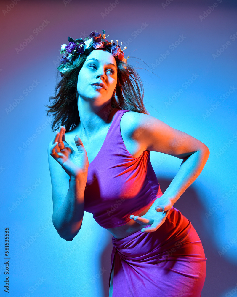 Low angle portrait of pretty girl wearing pink outfit, gestural arm ...