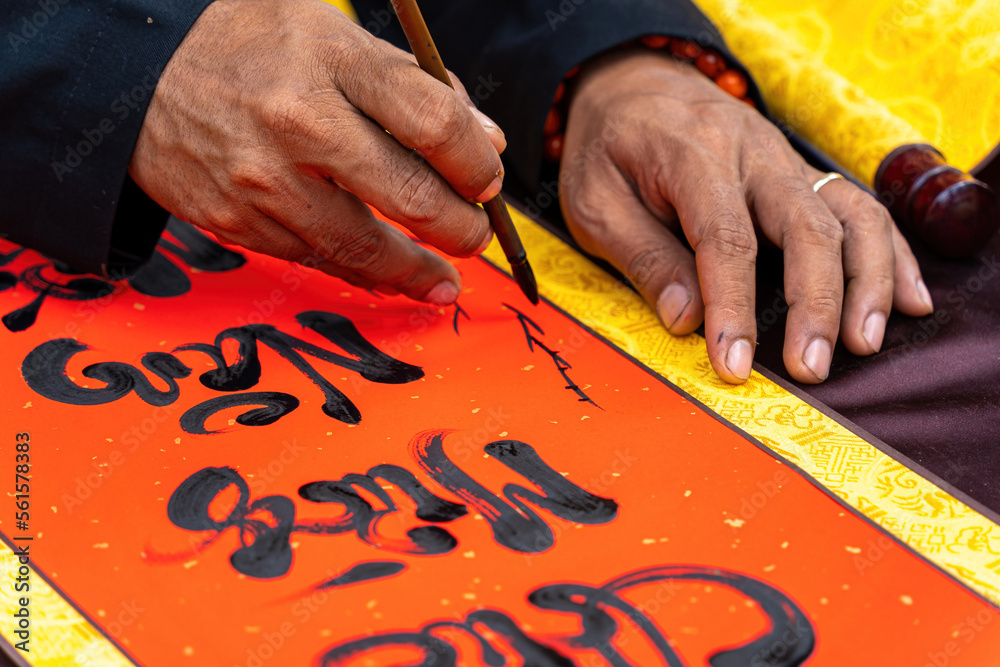 Selective focus of hand of Vietnamese scholar writes calligraphy at ...