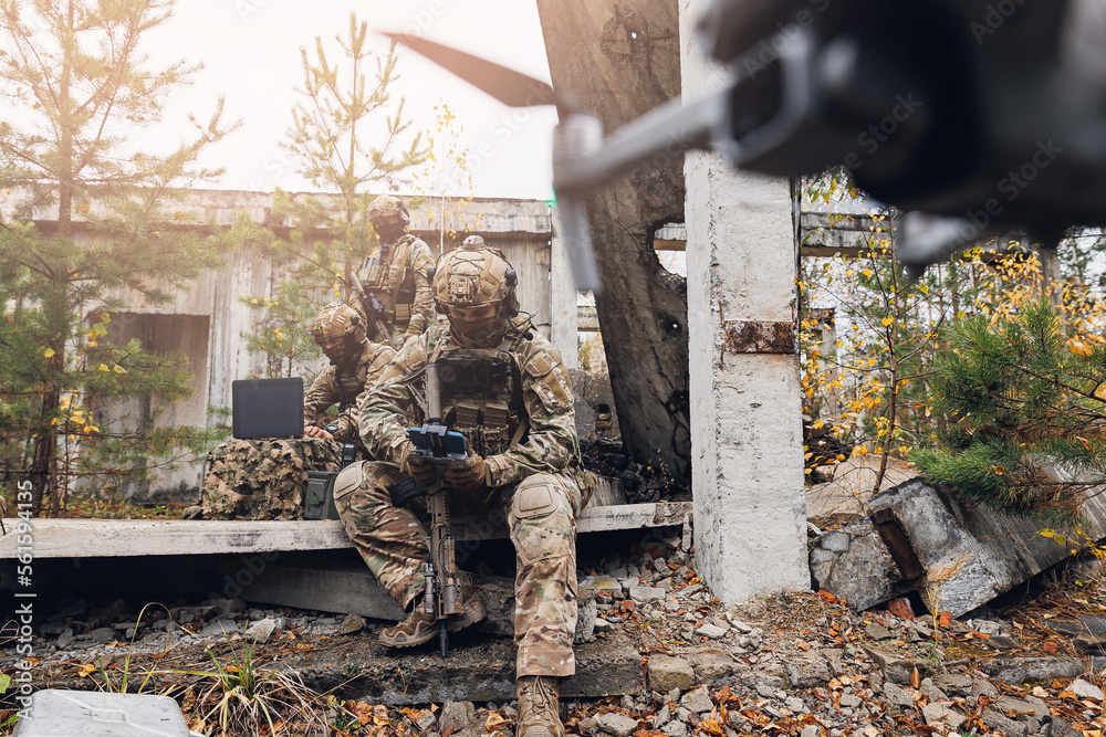 Modern army soldiers using aerial drone for artillery guidance and ...