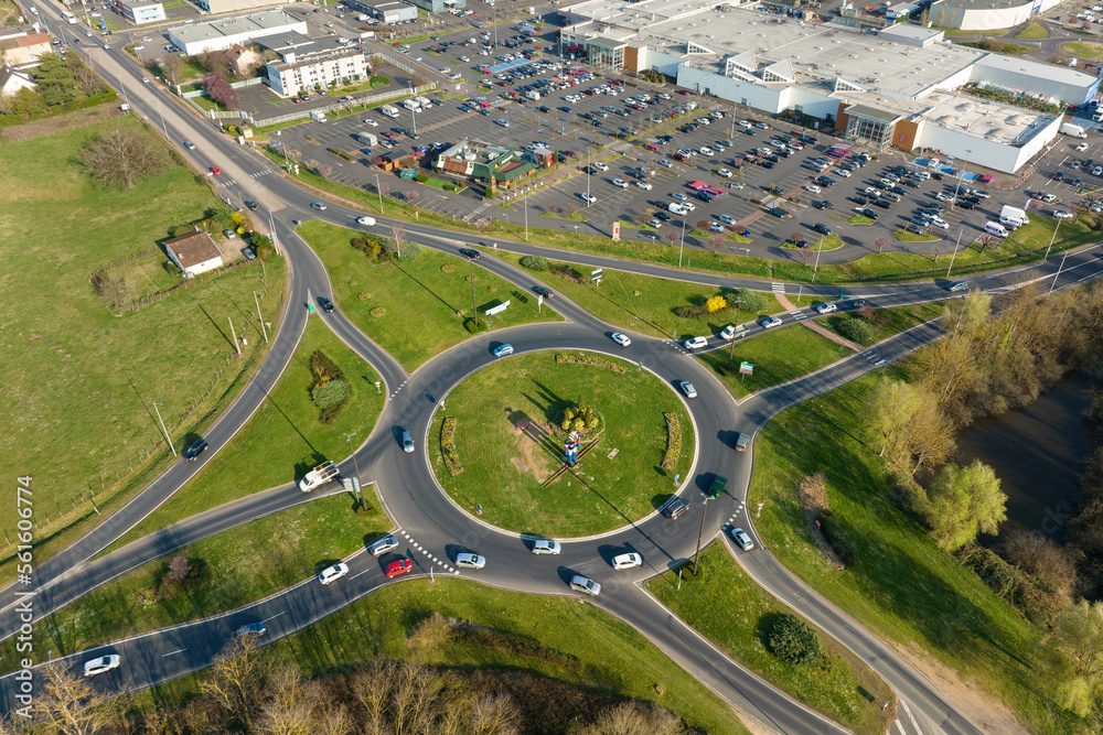 Aerial view of road roundabout intersection with moving heavy traffic ...