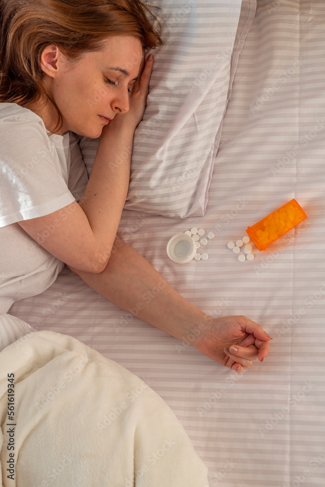 Sleeping pills, medicine. Woman sleeping in bed at home. Effects of ...