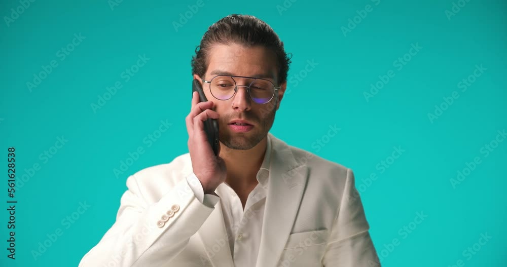 worried Turkish man in white suit with open collar shirt talking on the ...