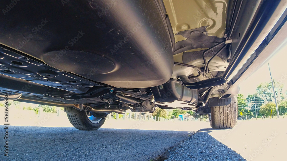 View of the car by auto mechanic from below. Automobile exhaust system ...