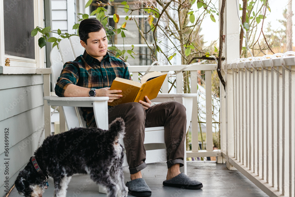 Transgender man with dog reading Stock Photo | Adobe Stock