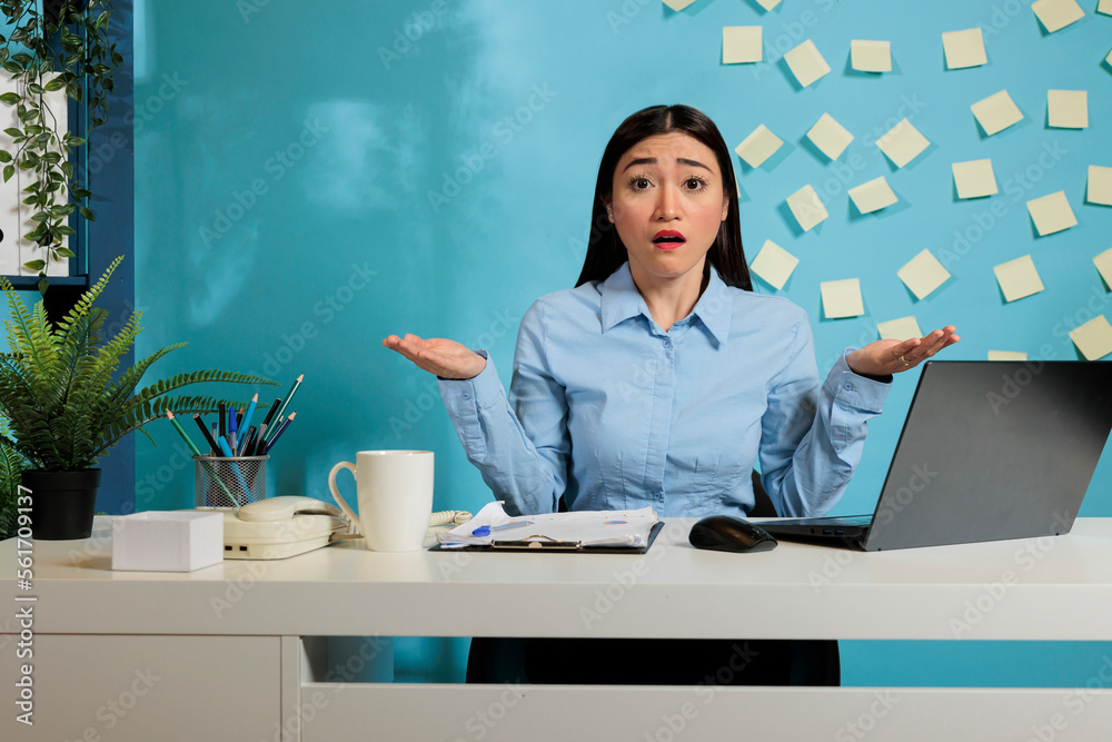 Confused asian woman raising hands and shoulders, unsure of the answer ...