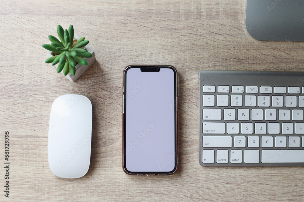 Top view of minimal workspace with blank screen smartphone, keyboard ...