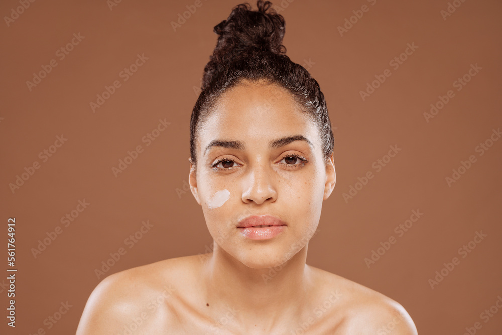 Foto de Young black woman using skincare cream, face product with ...