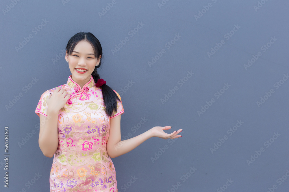 Beautiful Asian woman with long hair who wears pink Cheongsam dress in ...
