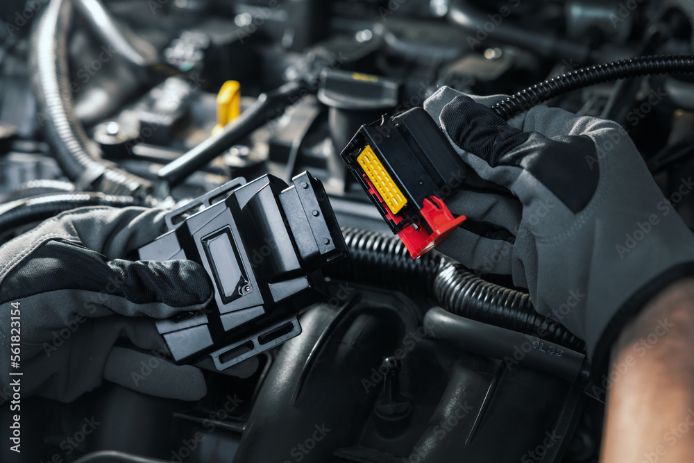 mechanic installing chip tuning box on car engine Stock Photo | Adobe Stock