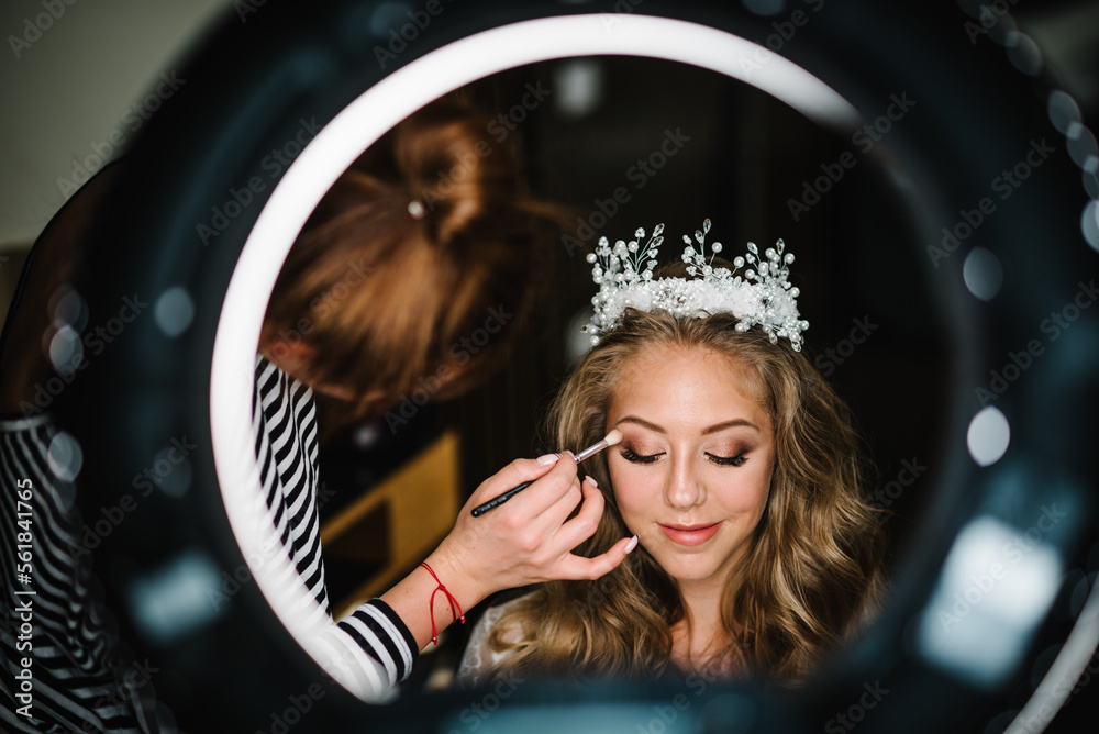 Makeup concept. The makeup artist makes the perfect makeup on the skin ...