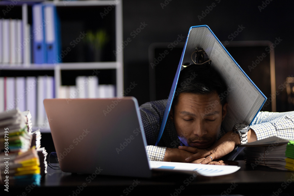 Business people in the night office who work overtime are sleepy and ...