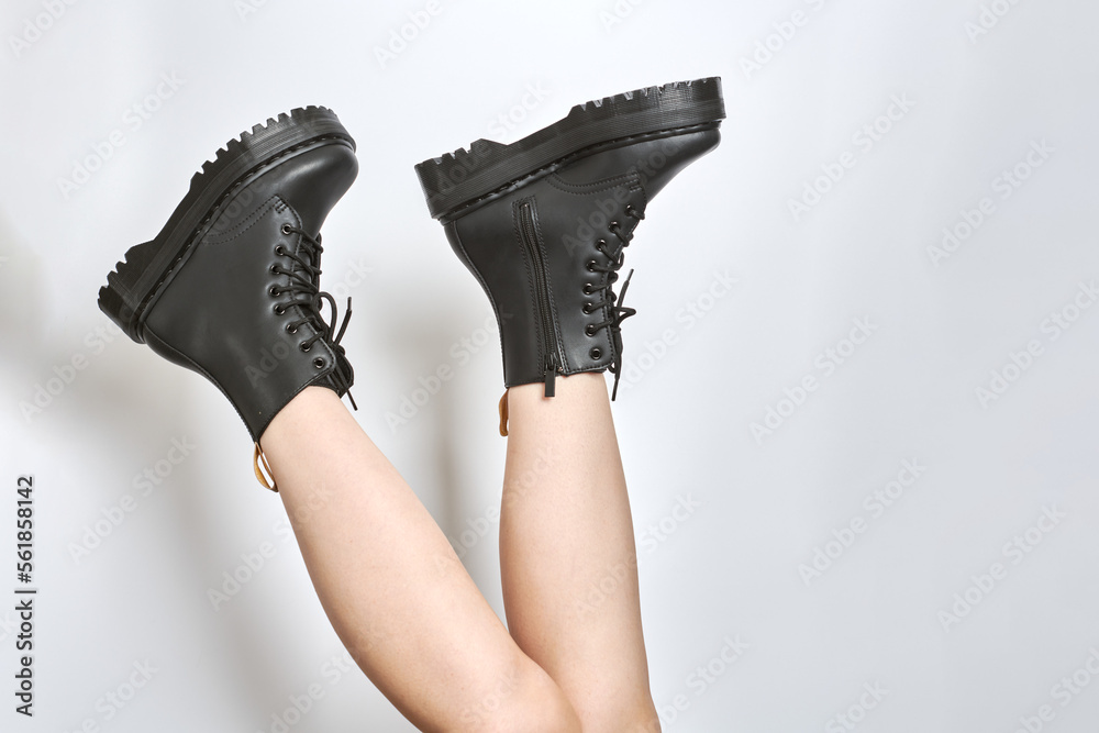 Woman legs in black combat boots on high heel platform with lug soles ...