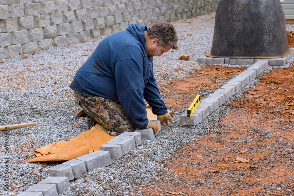 Pavers stone pathway paving master lays paving stones by using ...