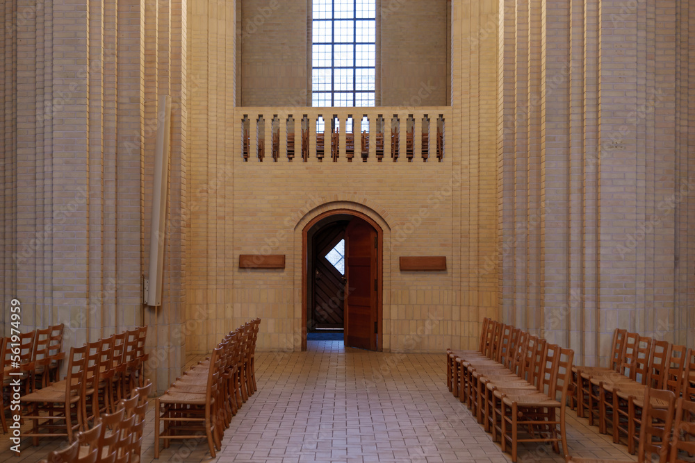 Interior view at the aisle and nave area with single table and candle ...