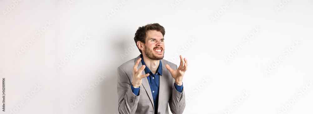 Foto de Angry man in business suit look left with hatred, stare aside ...