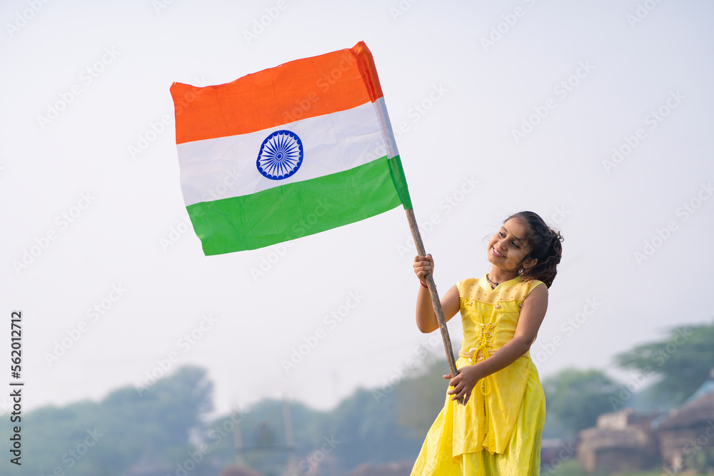 Cute indian little girl waving national tricolor flag at agriculture ...