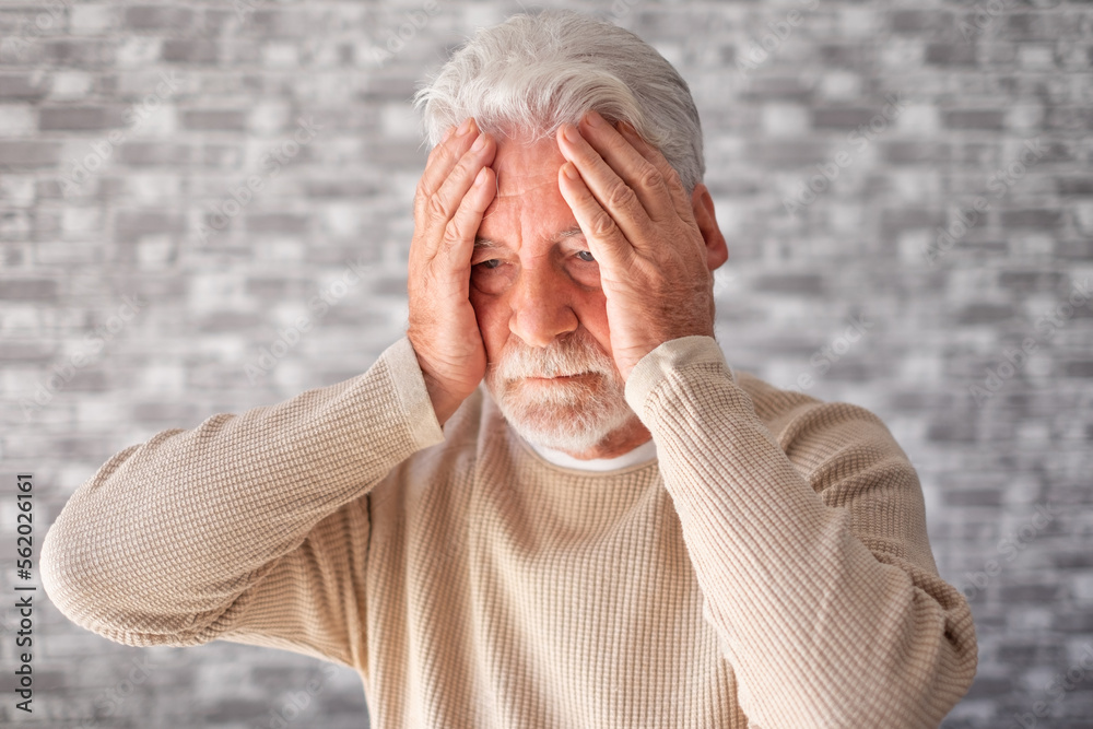 Desperate unhappy old man with hands in the face, senior bearded male ...