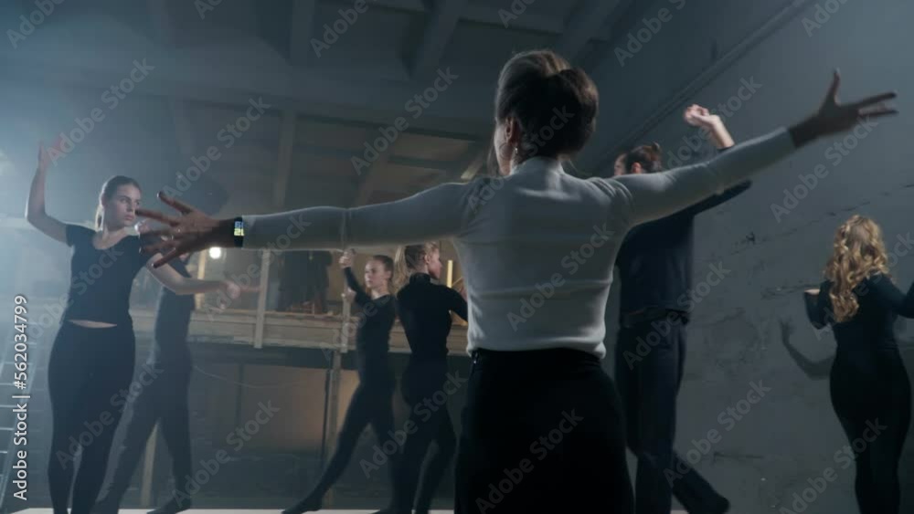 Theater director moving hands rehearsing show with actors and actresses ...