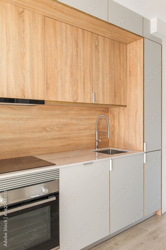 Closeup of piece of modular kitchen furniture made of light wood ...