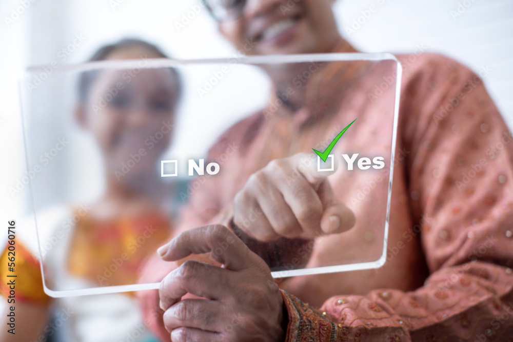 Indian father wearing traditional costume points to a translucent ...