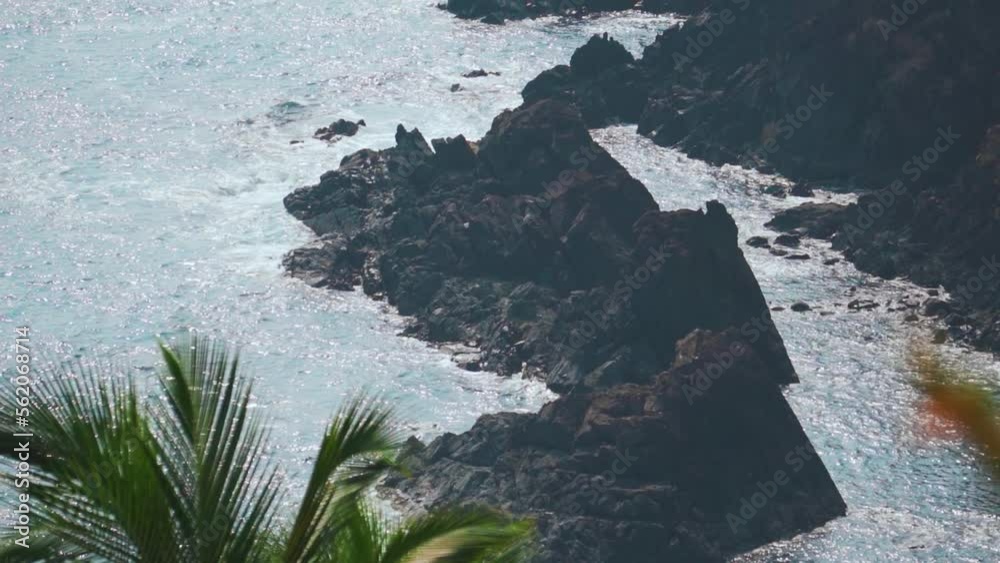 Sea waves striking the rock in the middle of the sea at Kakolem beach ...