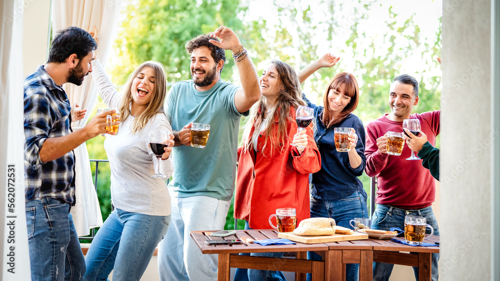 Young people having fun eating at home balcony dinner party - Happy ...