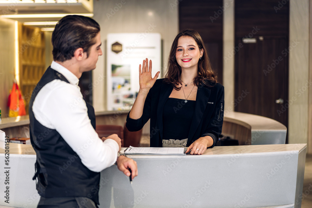Young handsome businessman talking and check in Register information ...