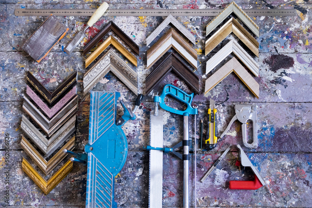 Overhead view of picture frame corners with work tools on table in ...